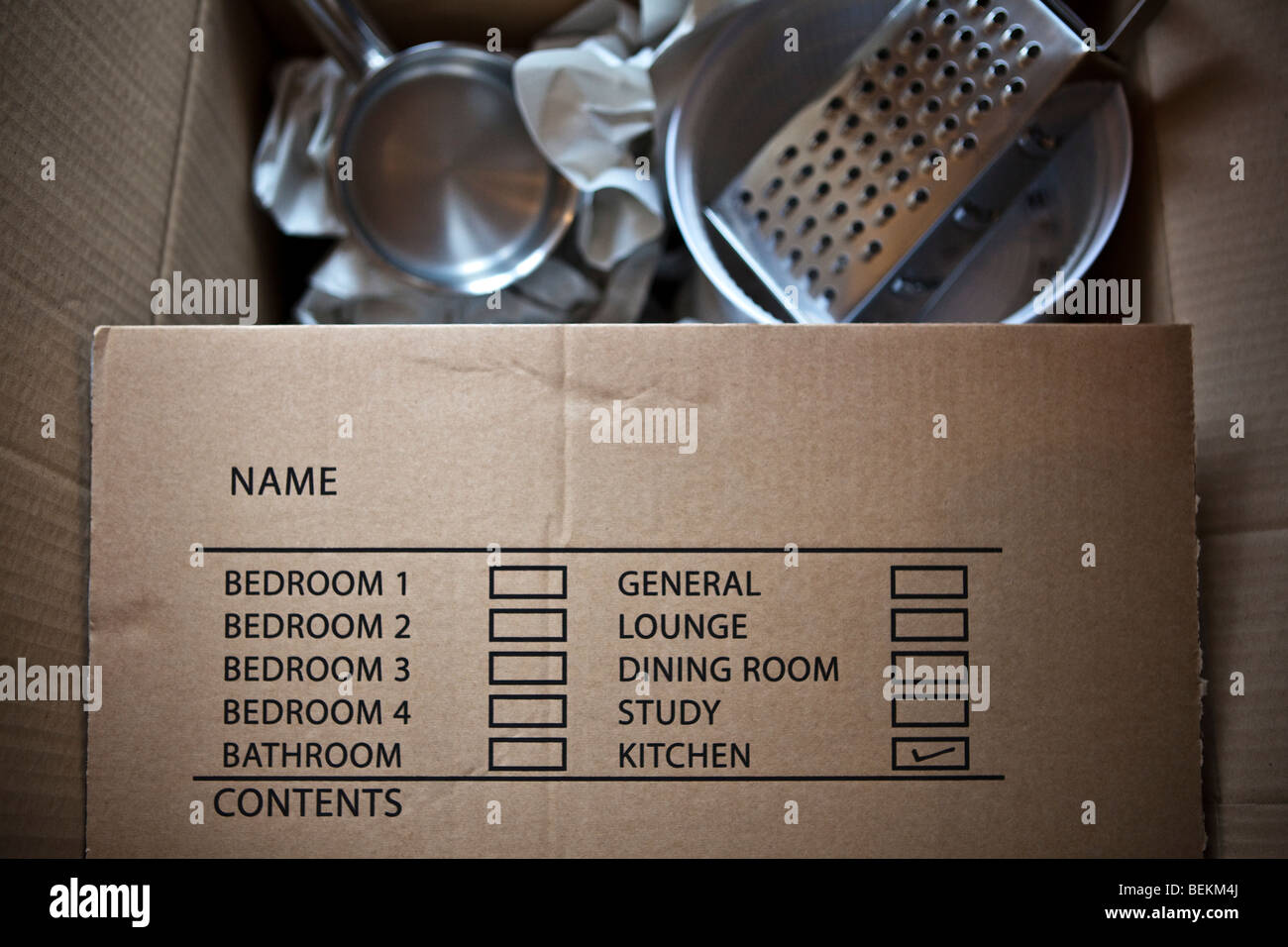 Kitchen items packed into a box / carton as part of a house move. The ...
