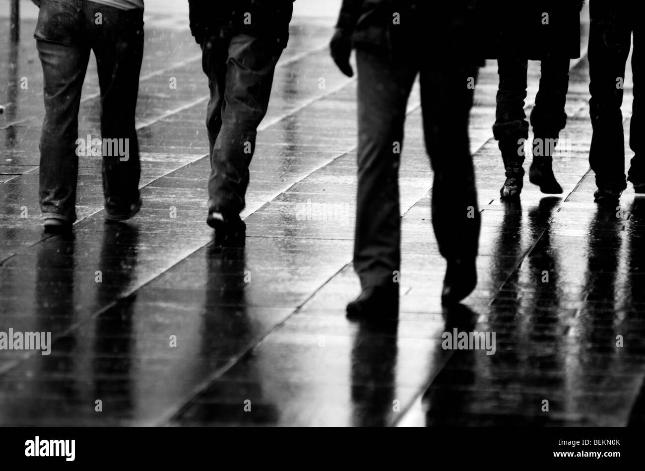 People walking on wet sidewalk Stock Photo - Alamy