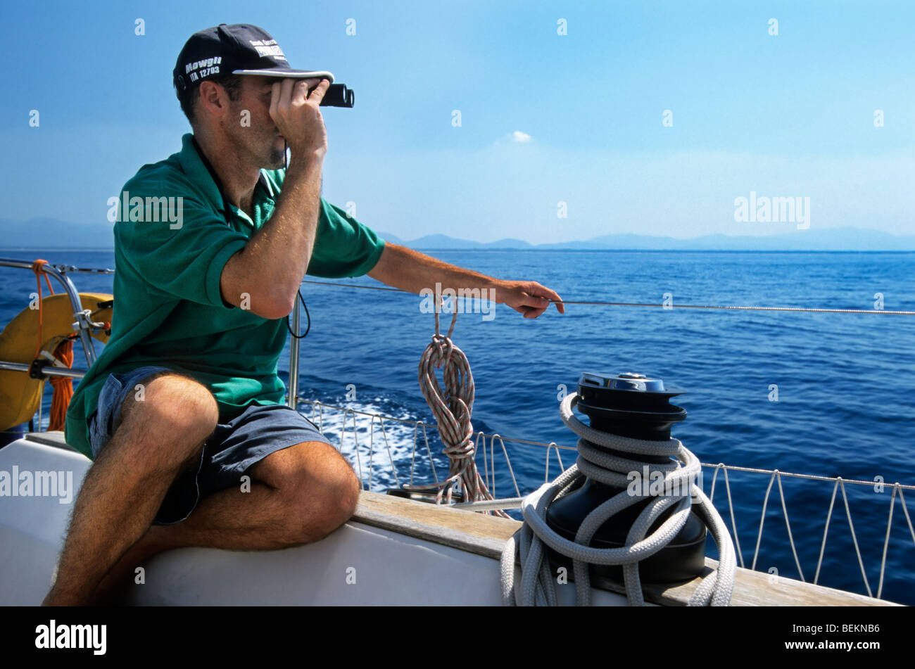 Yachtsman with binoculars on sailing boat, Mare, Tuscany, Italy Stock ...