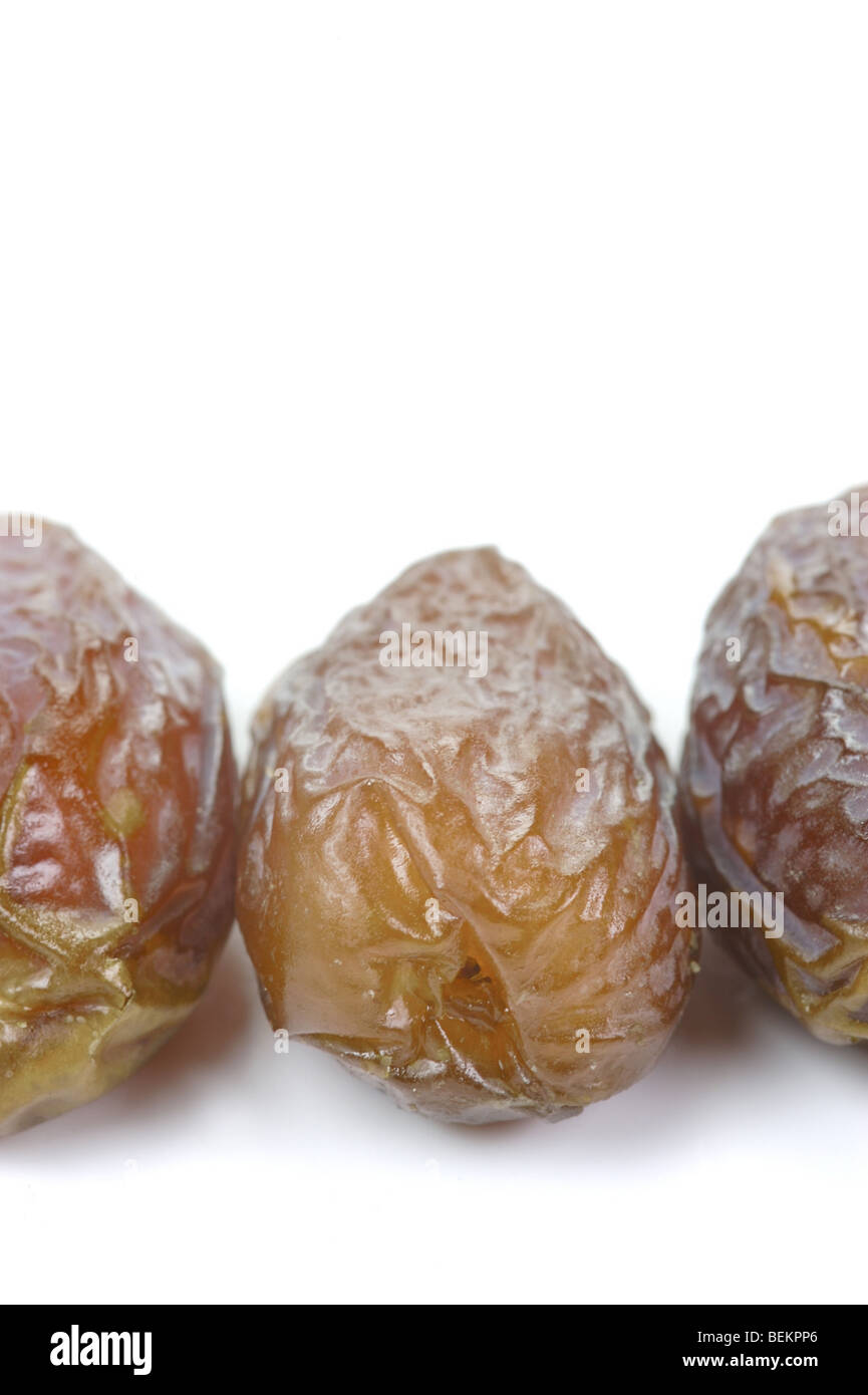 Dates isolated against a white background Stock Photo - Alamy