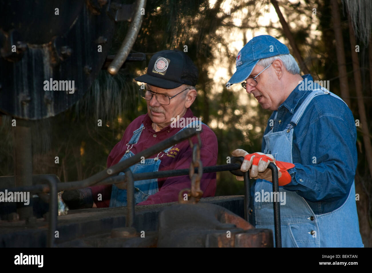 Two engineers working on a 1930s steam locomotive in Florida Stock ...