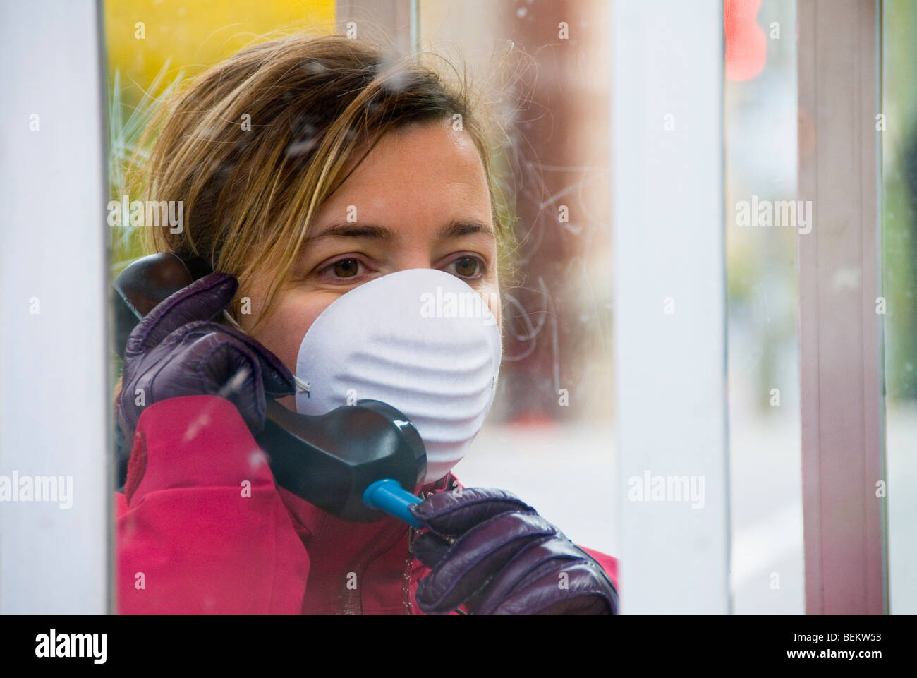 Woman wearing mask talking on a public phone Stock Photo - Alamy
