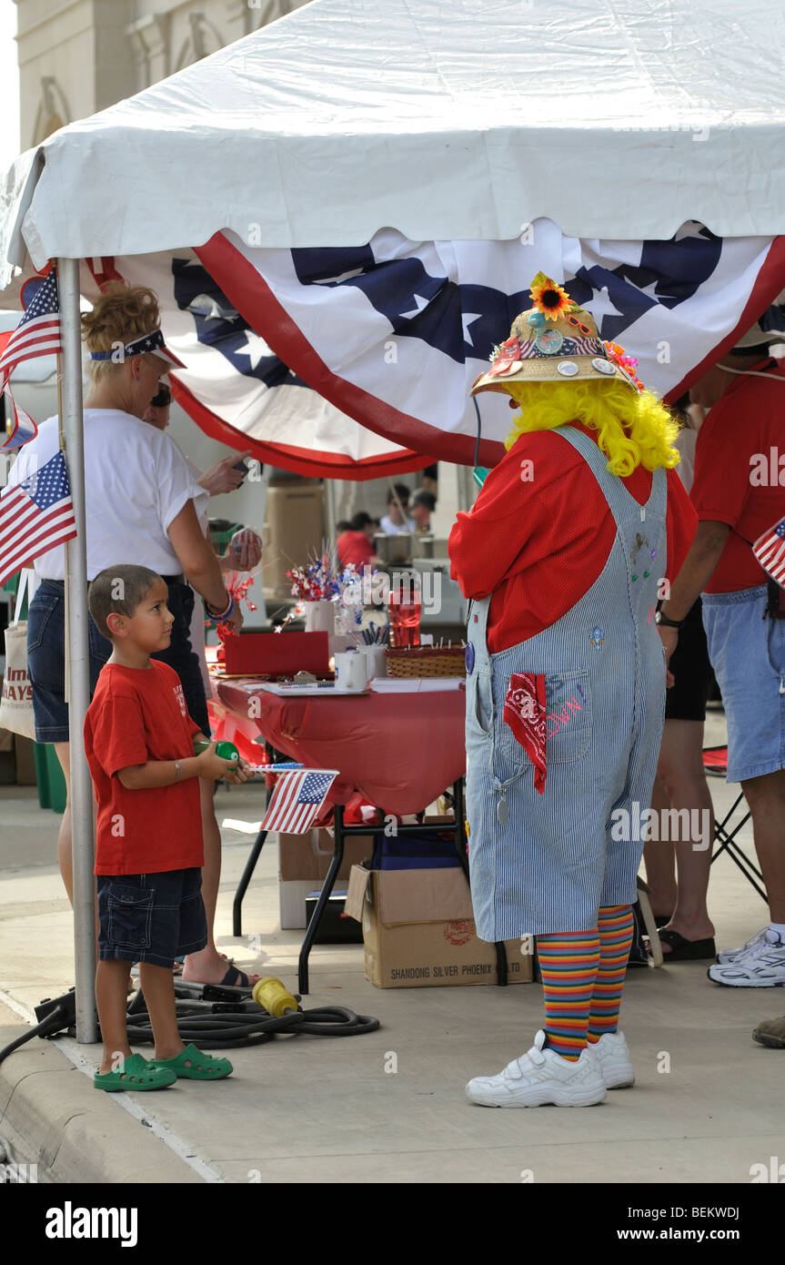 Boy talking to clown Stock Photo - Alamy