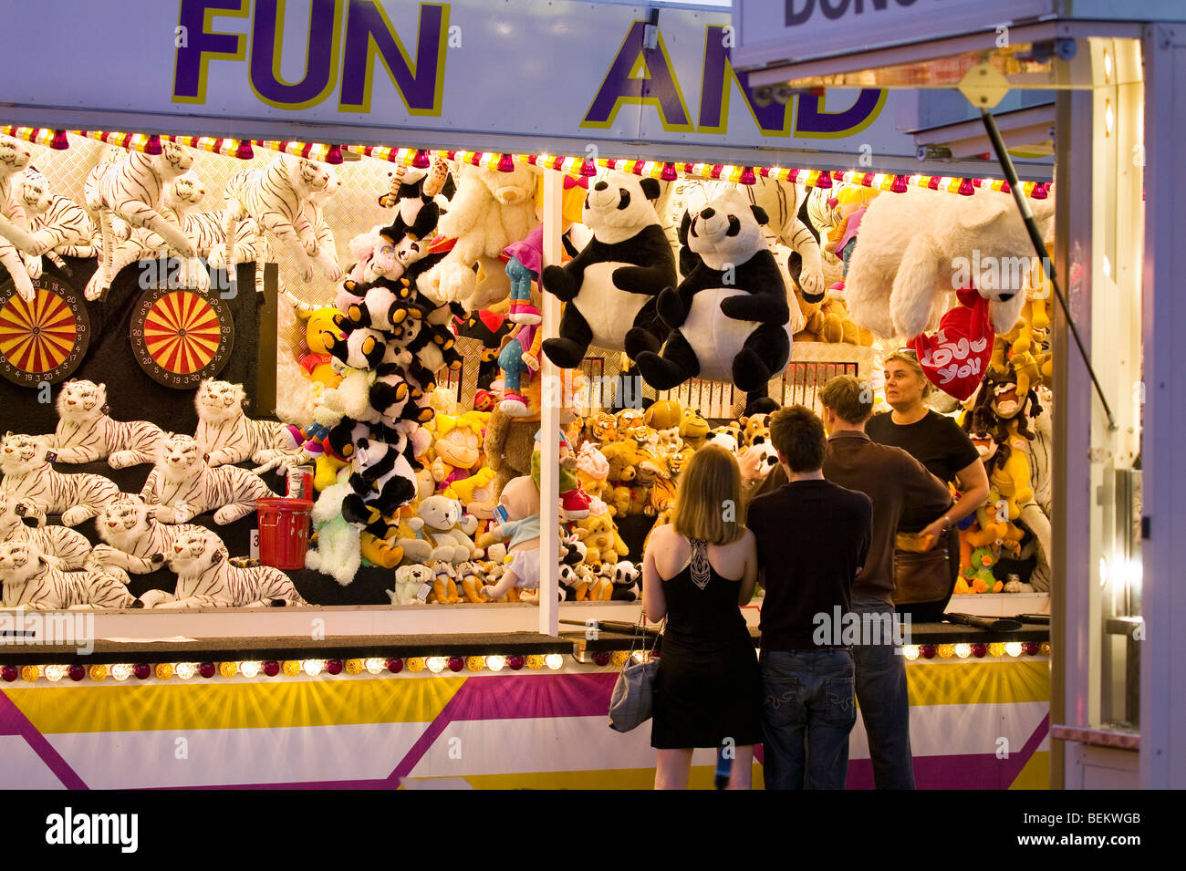 Darts side stall with many stuffed toys on display. Midsummer Fair ...