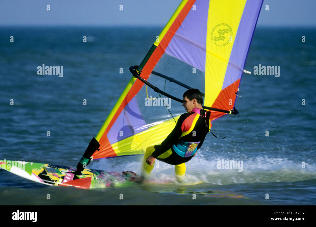 Windsurfer in wetsuit sailing at sea Stock Photo - Alamy