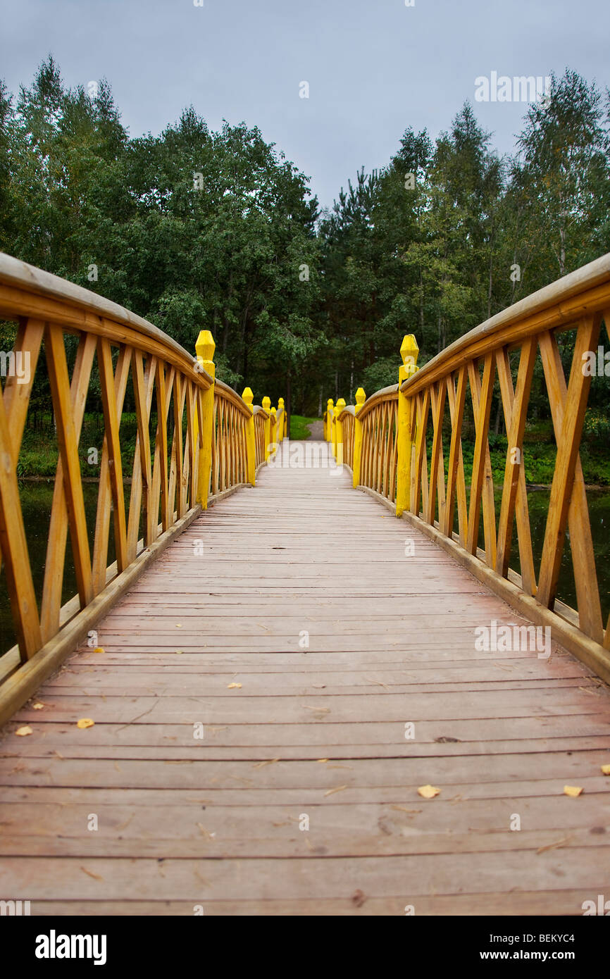 Wood bridge over water to forest perspective view Stock Photo - Alamy