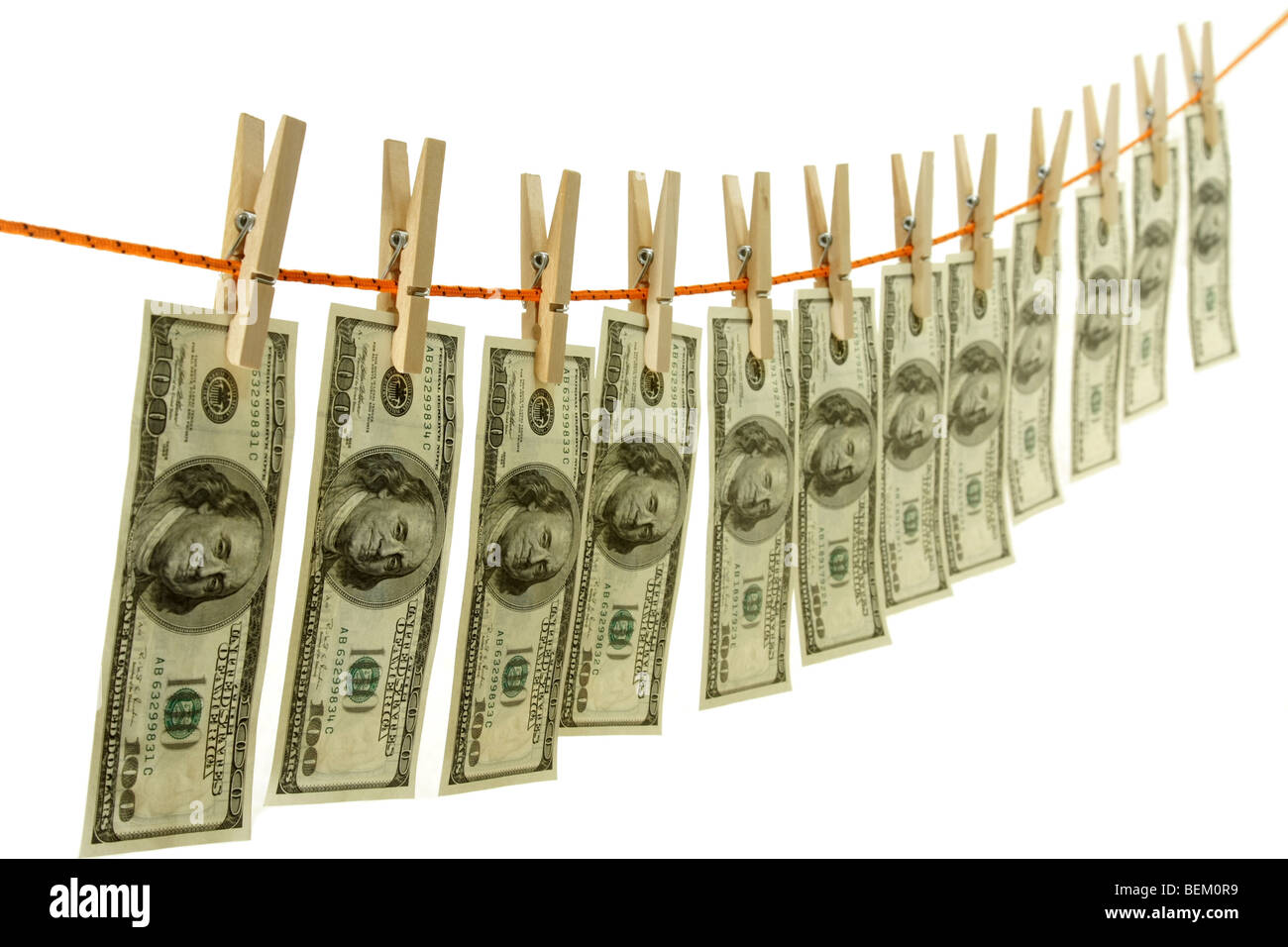 Money laundering on string with clothespins isolated on white ...