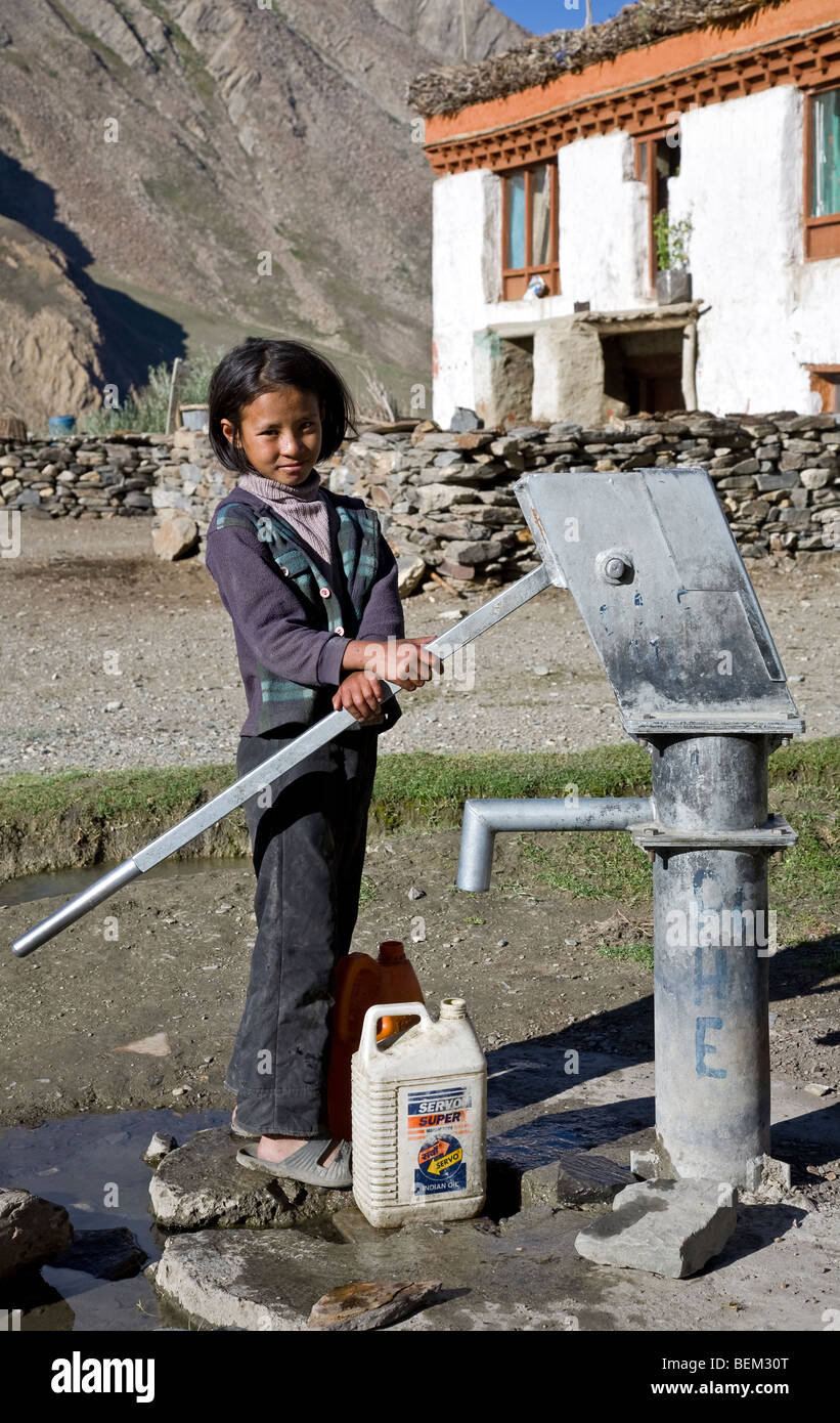 Girl pumping water. Rangdom village. Zanskar. India Stock Photo - Alamy