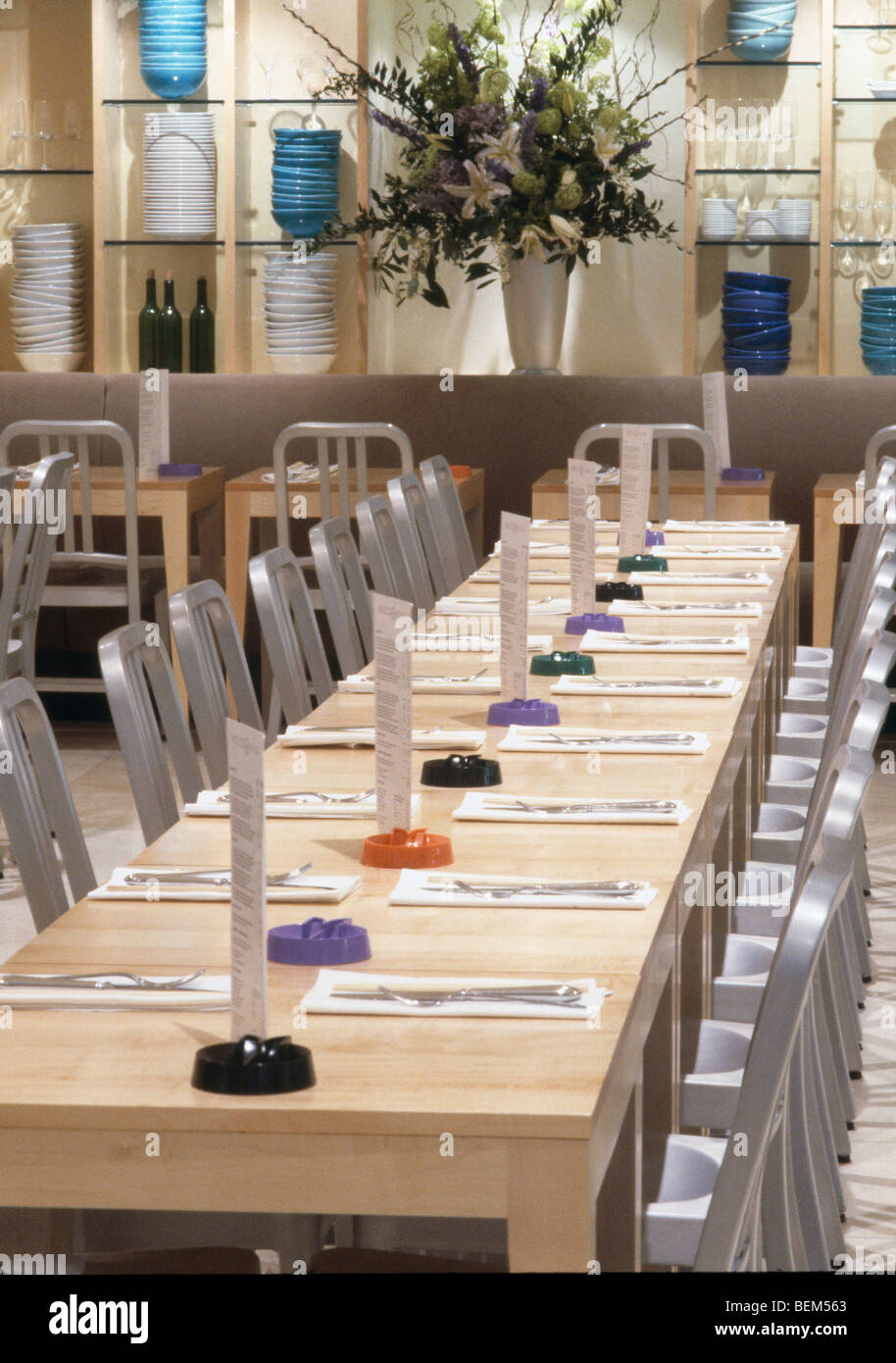 Metal chairs and pale wood tables in modern London restaurant designed ...