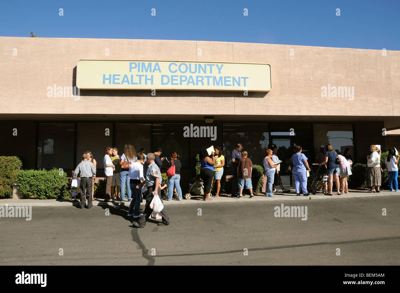 People line up to receive the 2009 H1N1 influenza, also known as the ...