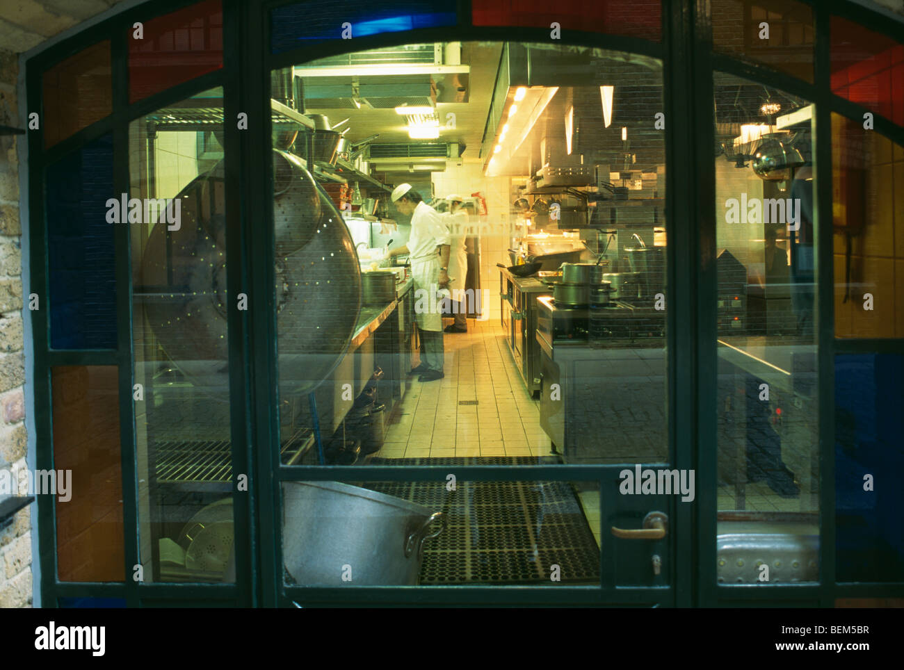 View through window of chefs in kitchen of modern restaurant Stock ...