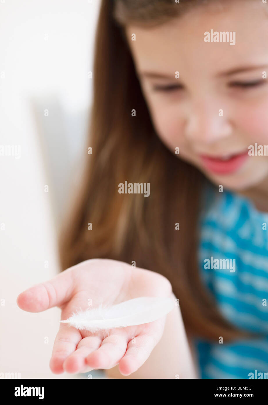 Child holding feather Stock Photo - Alamy