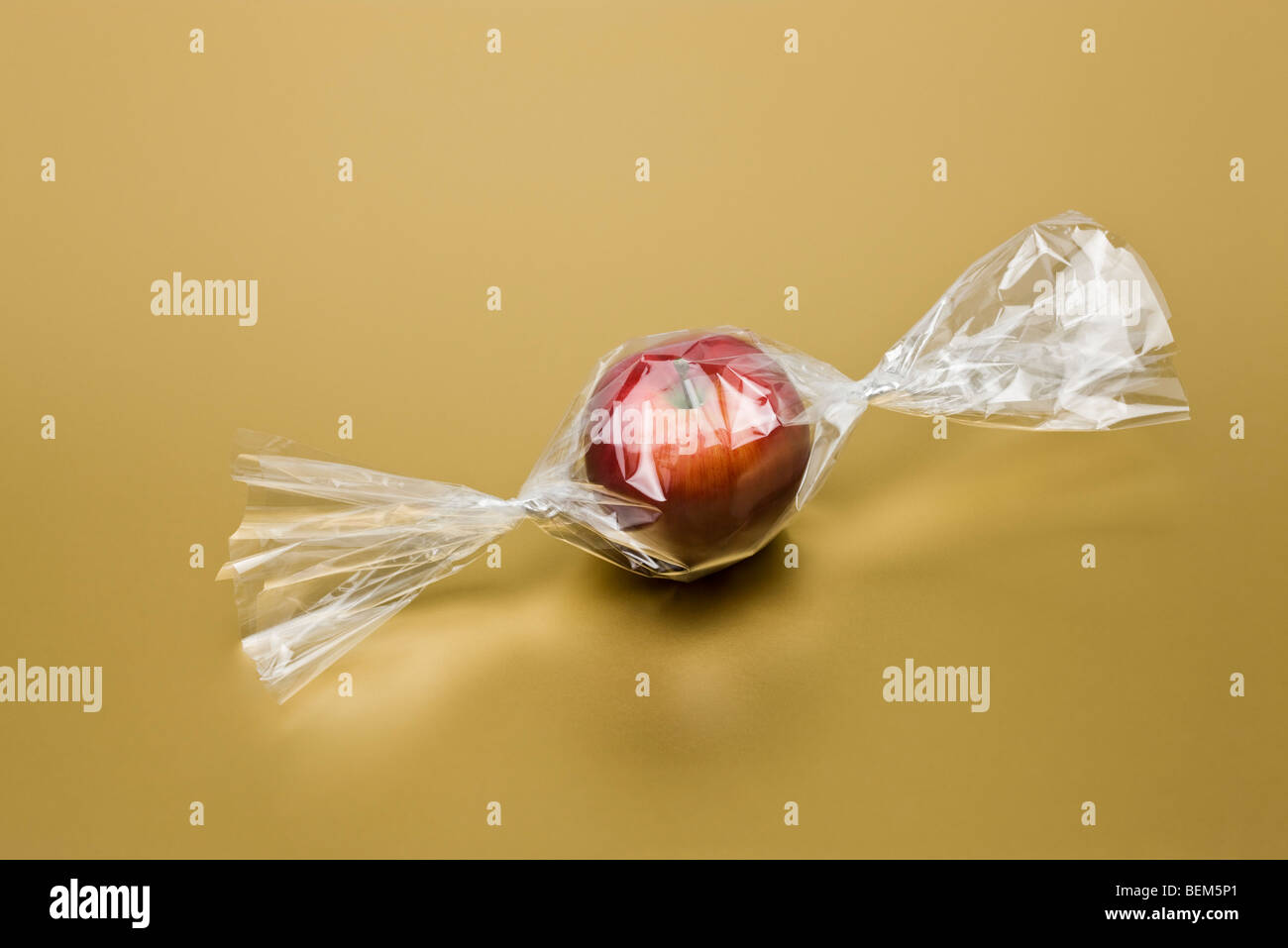 Food concept, fresh apple inside cellophane candy wrapper Stock Photo ...