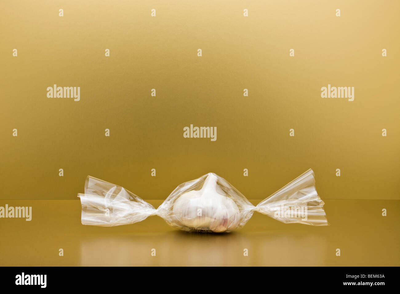 Food concept, head of garlic inside of cellophane candy wrapper Stock ...