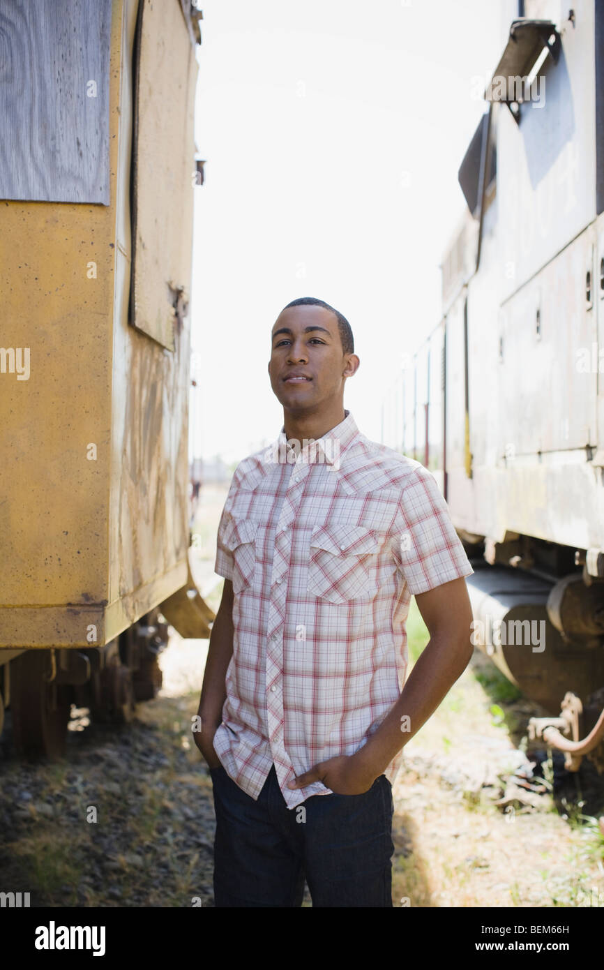 Young man beside train Stock Photo - Alamy