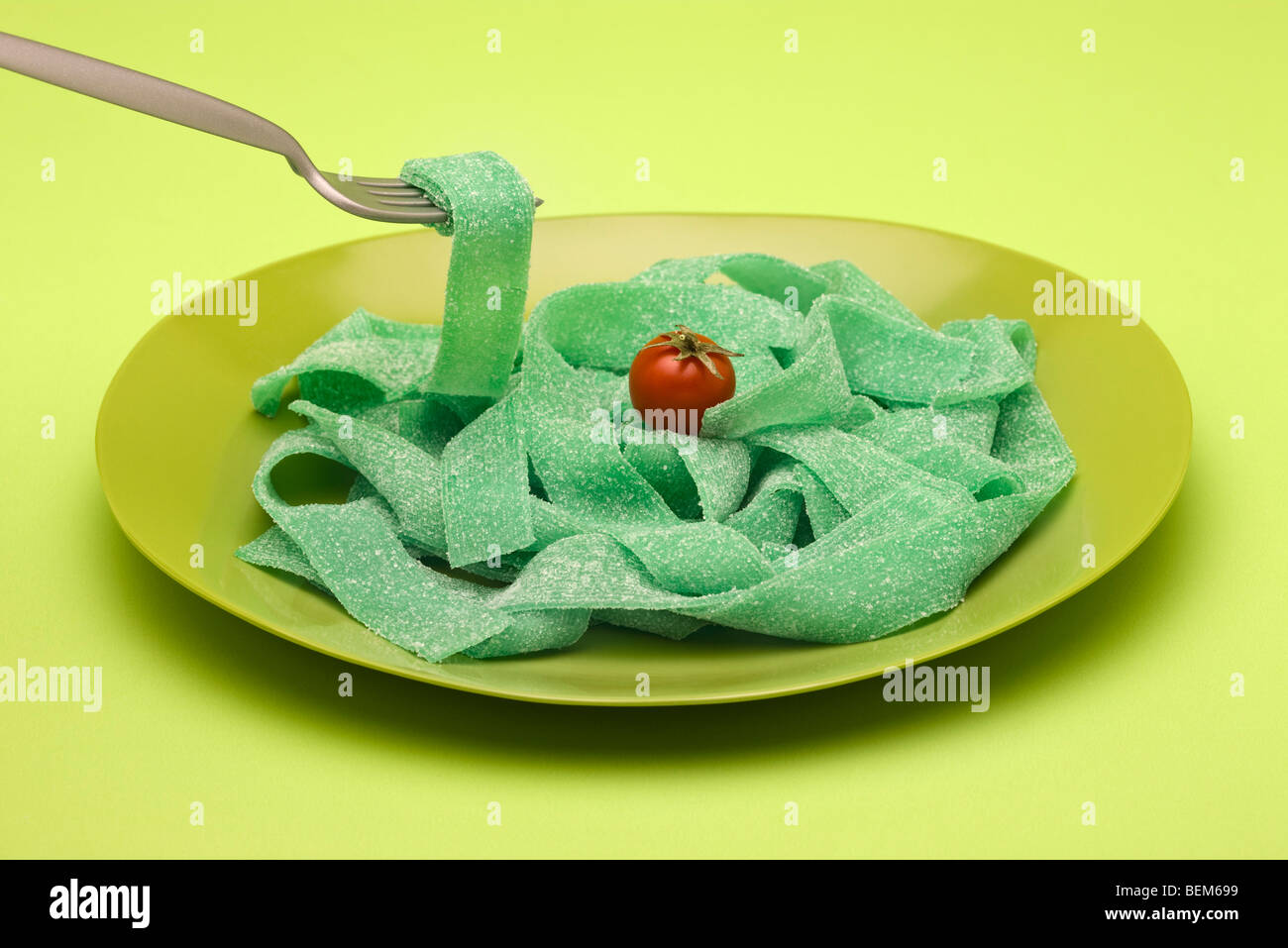 Food concept, plate of green gummy candy arranged like pasta, topped ...