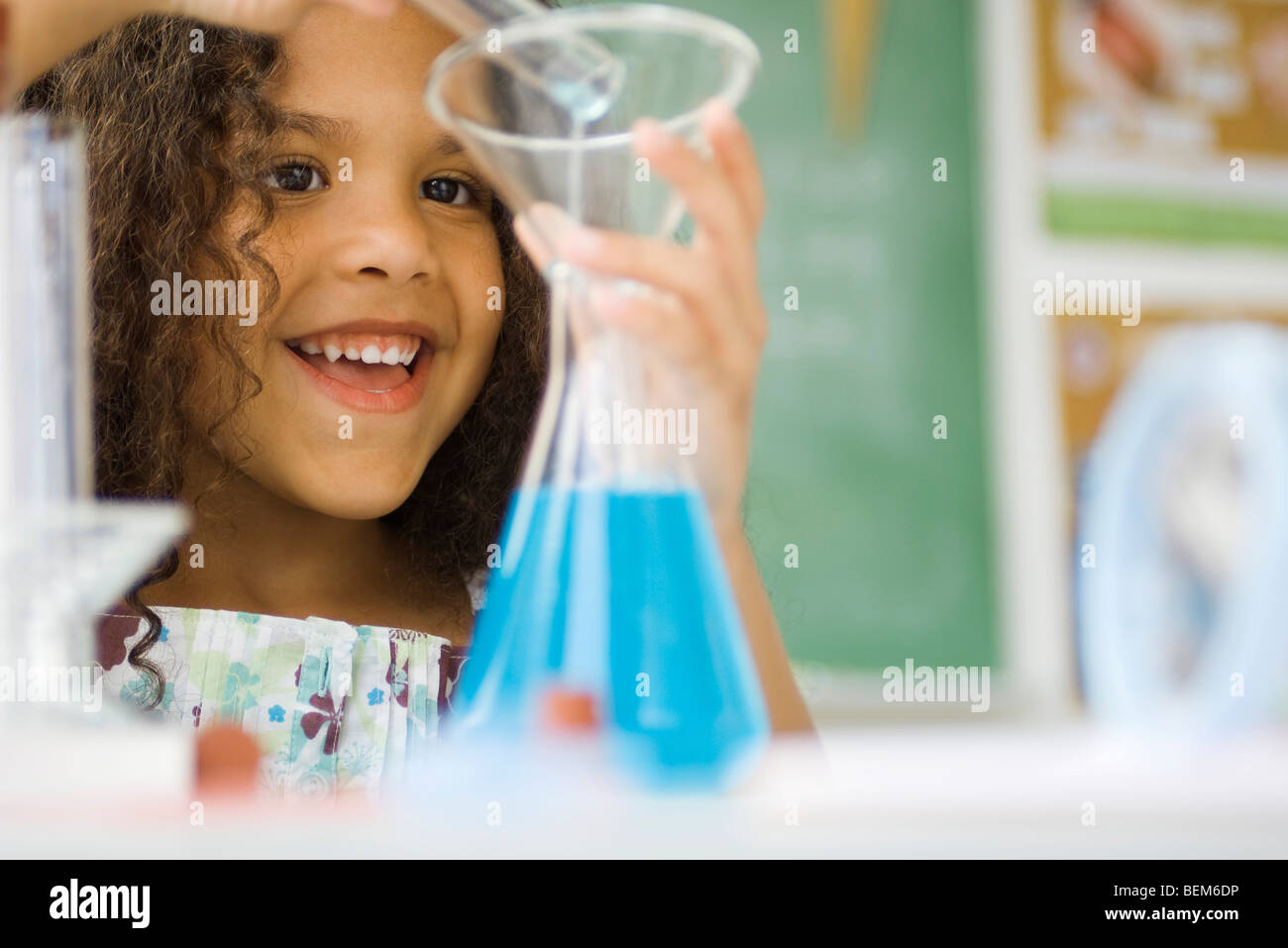 Little girl transferring liquid from test tube to beaker Stock Photo ...