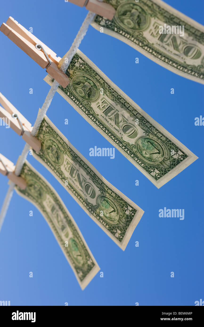 Dollars on clothes line Stock Photo - Alamy