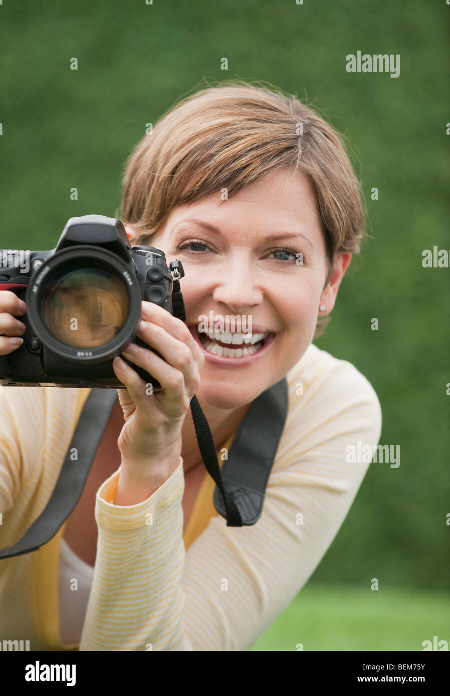 Woman taking picture Stock Photo - Alamy