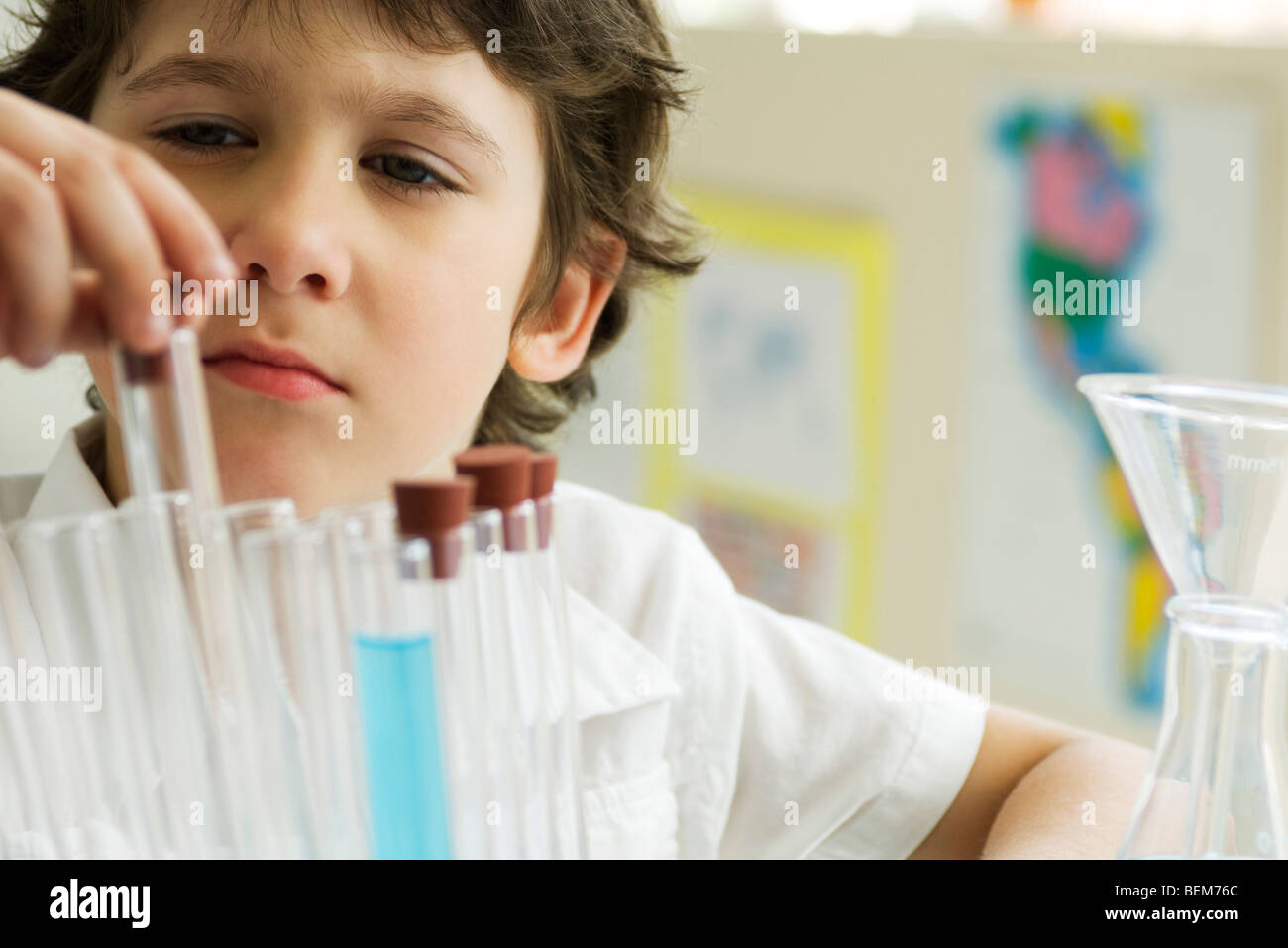 Boy removing test tube from rack, close-up Stock Photo - Alamy