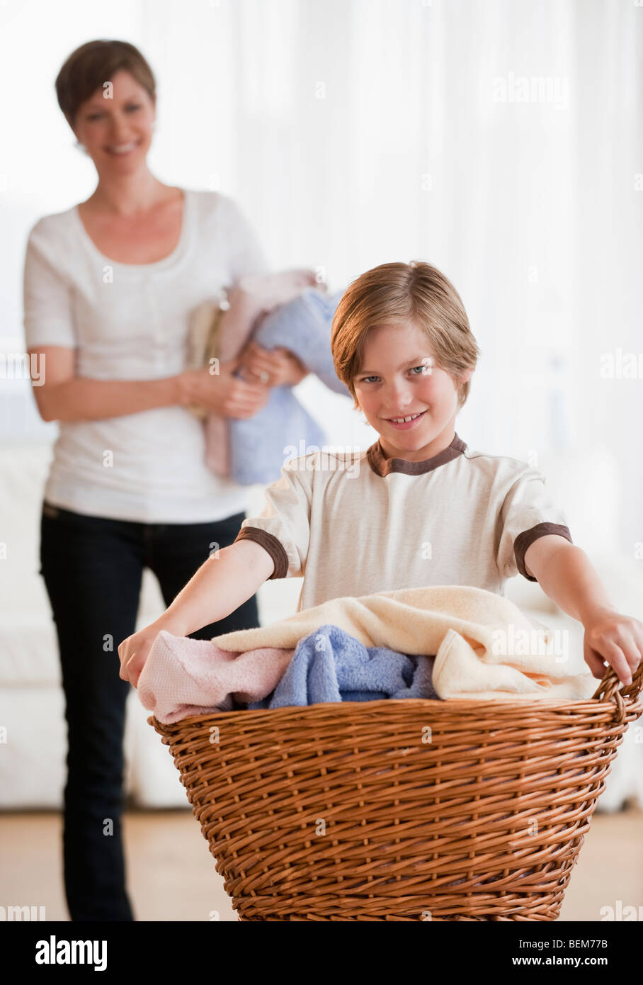 Mother and child doing laundry Stock Photo - Alamy