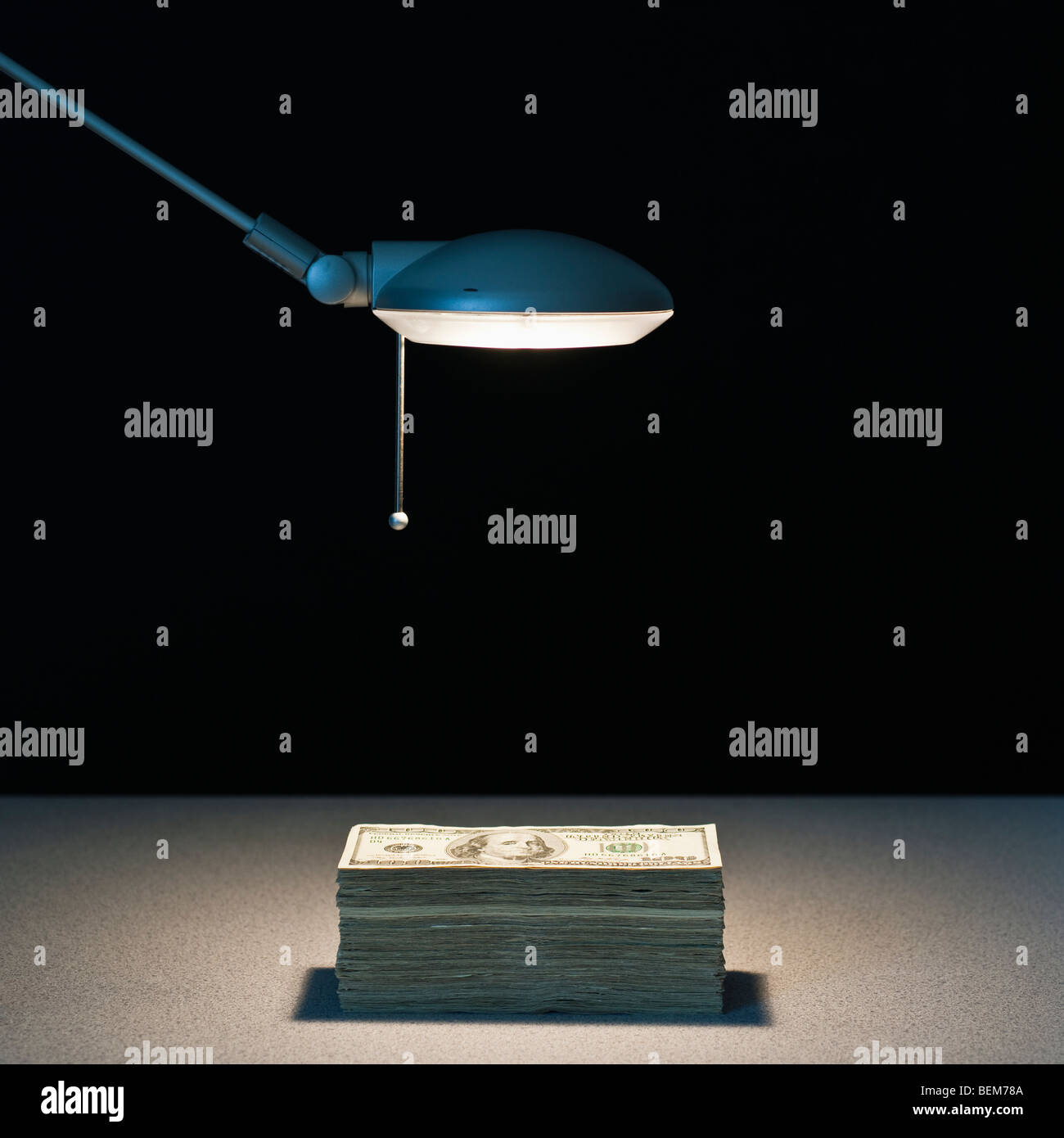 Light on money Stock Photo - Alamy