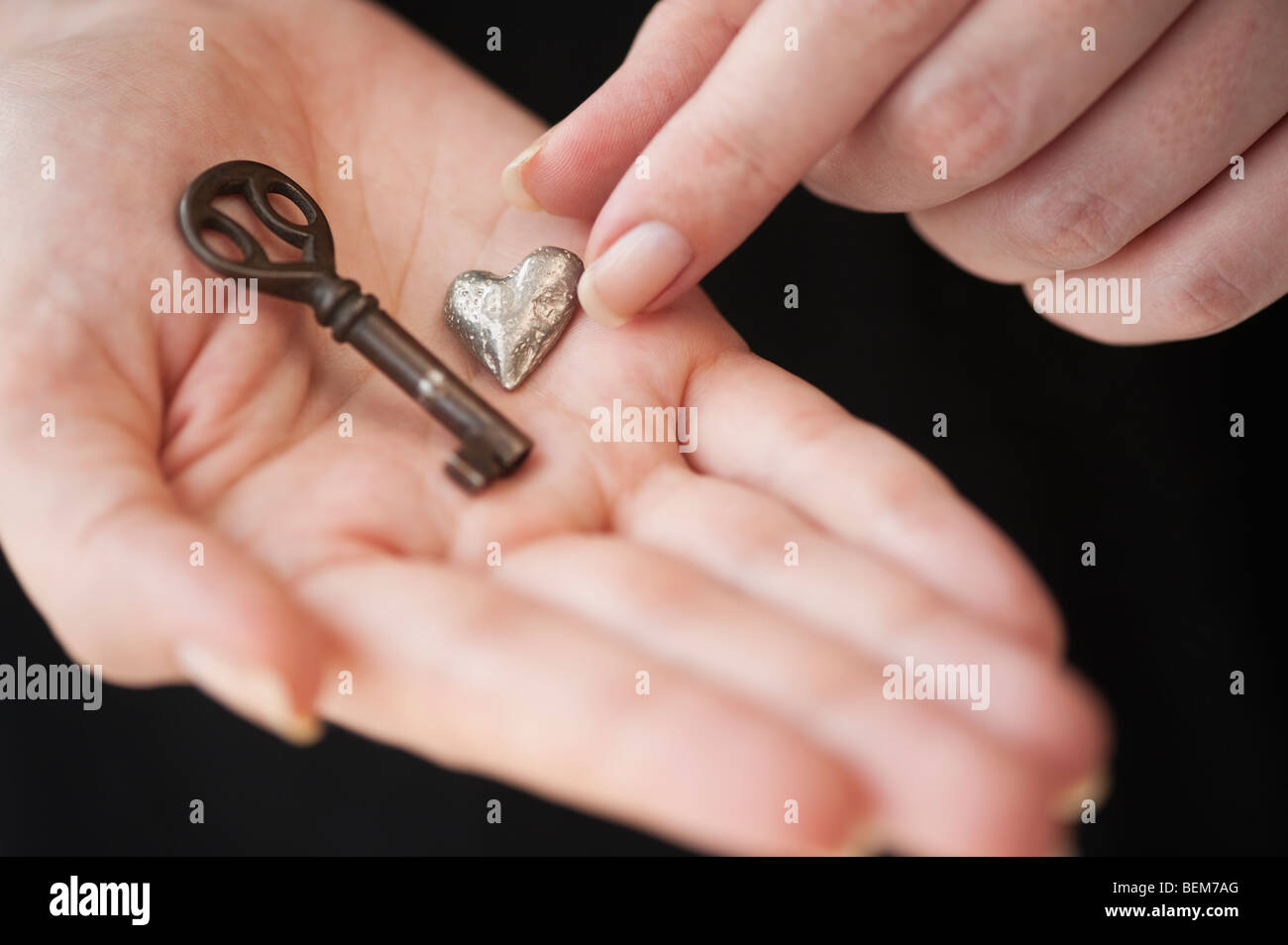 Hands holding heart and key Stock Photo - Alamy