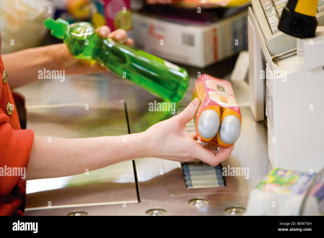 Cashier scanning items at checkout counter, cropped Stock Photo - Alamy