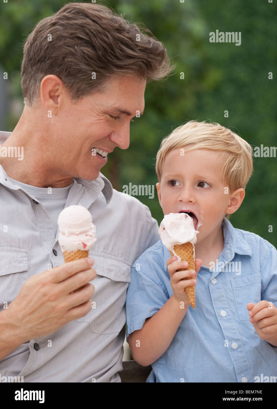 Father and child eating ice cream cones Stock Photo - Alamy