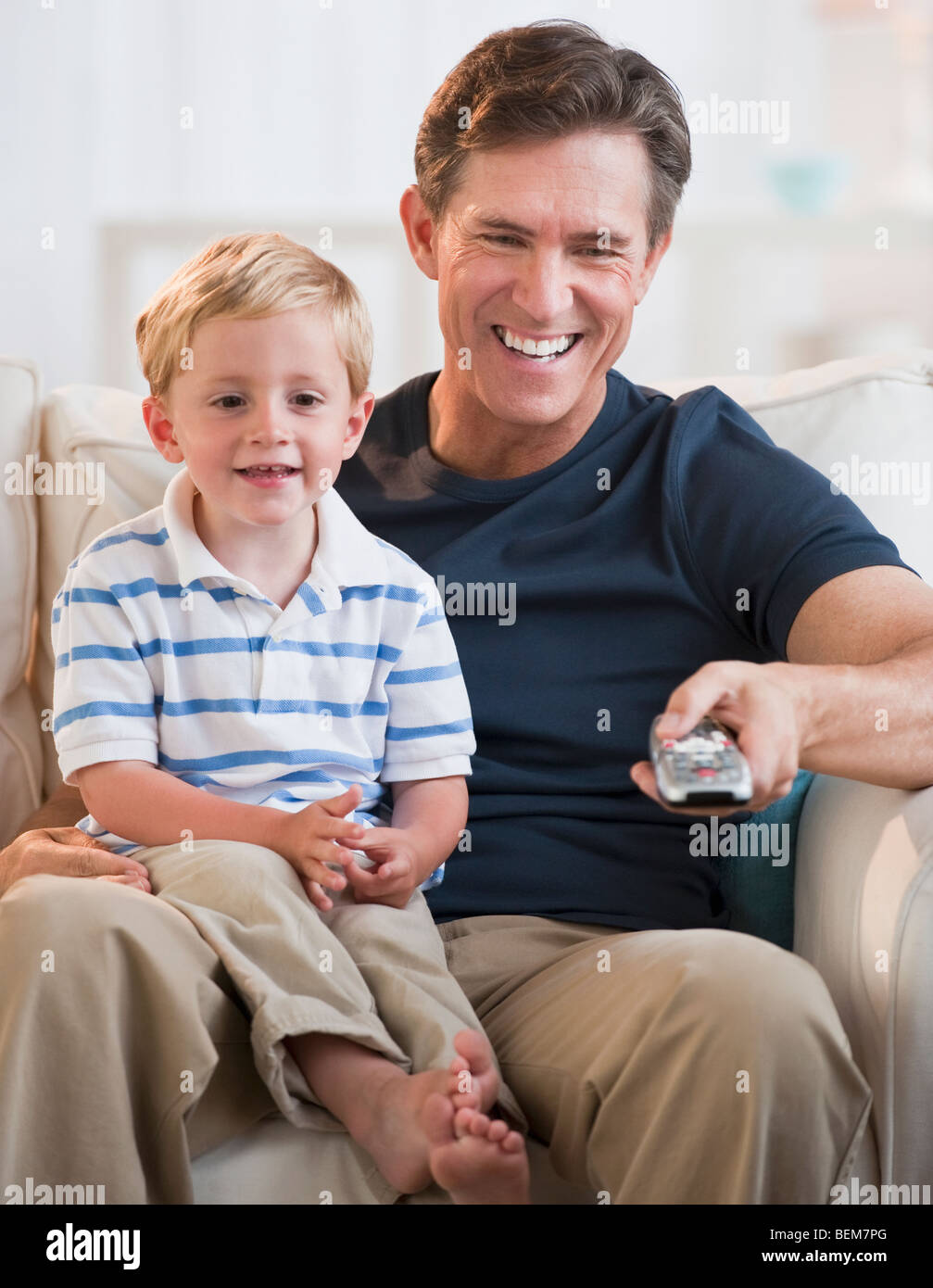 Father and child watching TV Stock Photo - Alamy