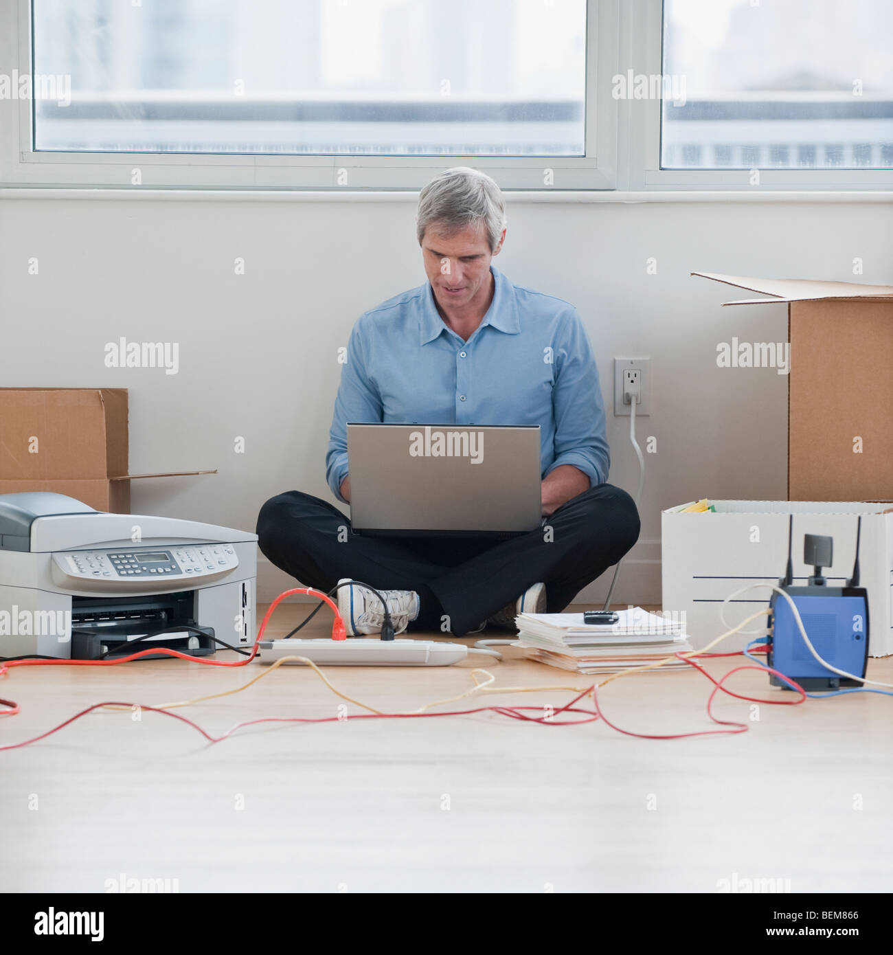 Man sitting while working on computer network Stock Photo - Alamy
