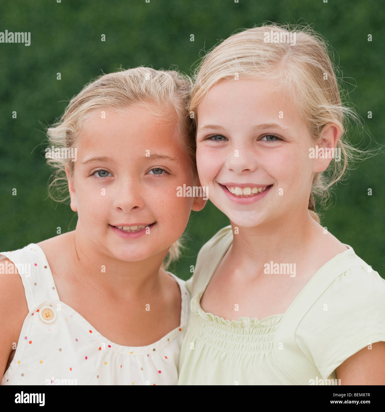 Young sisters smiling Stock Photo - Alamy