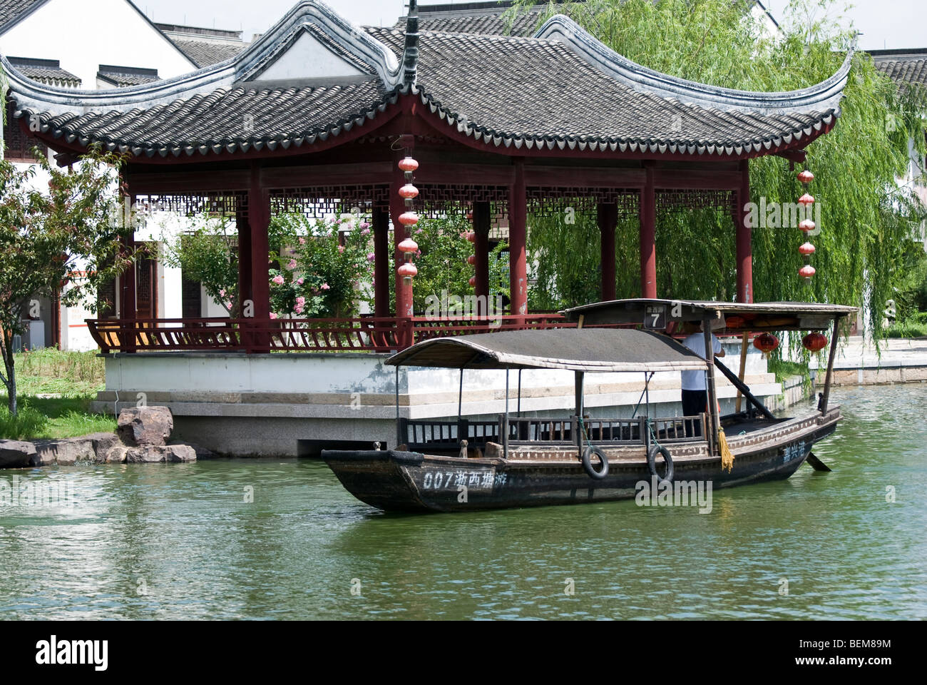 Traditional boat long the river in front of pagoda. Xitang is an ...