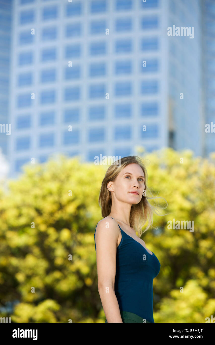 Woman in tank top standing outdoors, portrait Stock Photo - Alamy