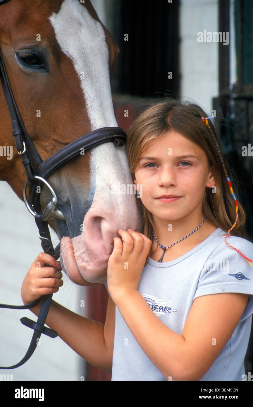 Close up of child with horse (Equus caballus) at stables, Belgium Stock ...