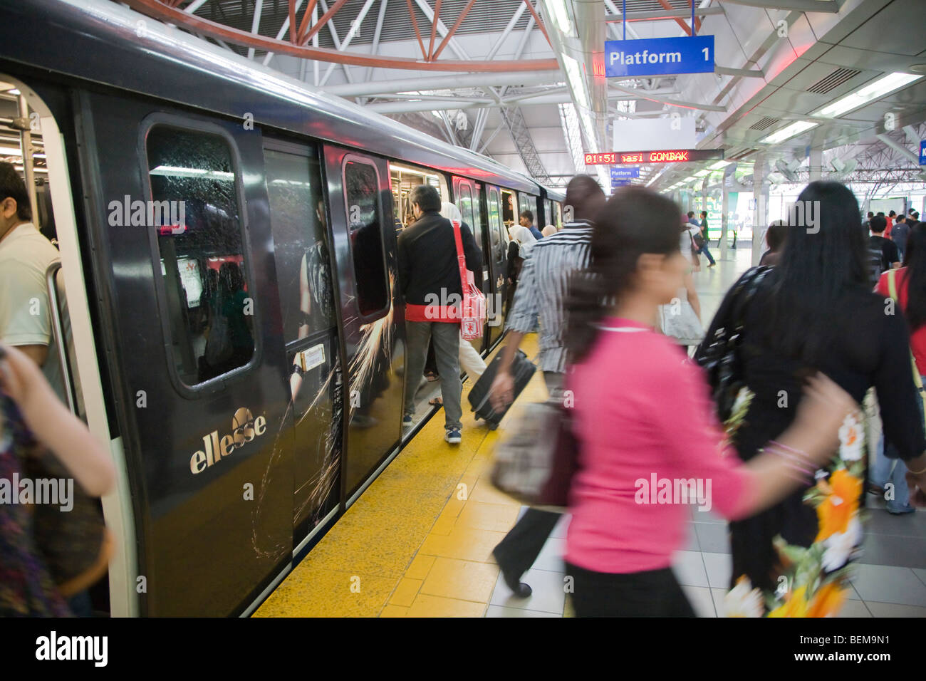 Passengers getting on and off RapidKL light rail train at Kuala Lumpur ...