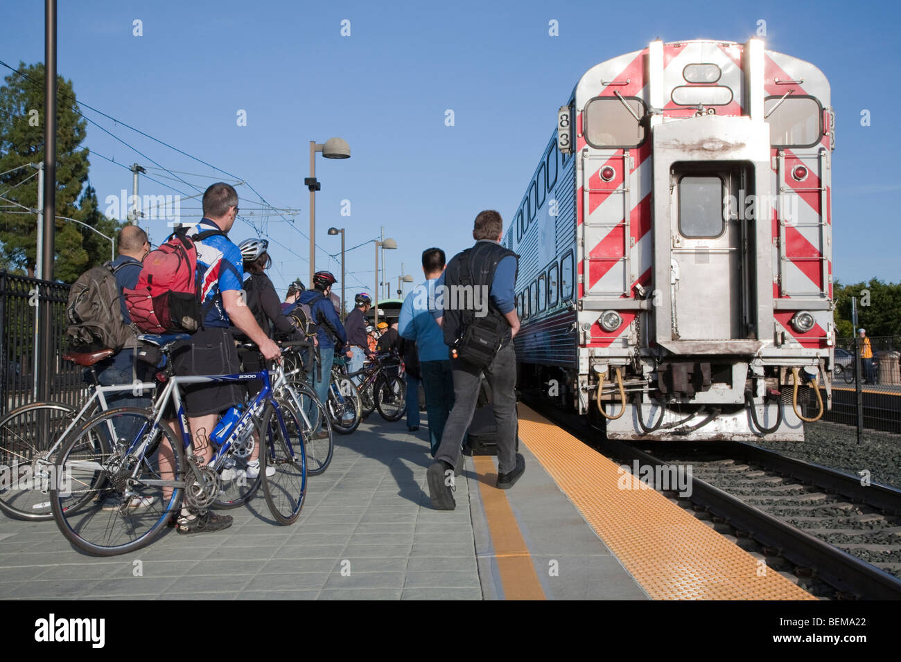 Bicyclists and commuters boarding a Caltrain train at the Downtown ...