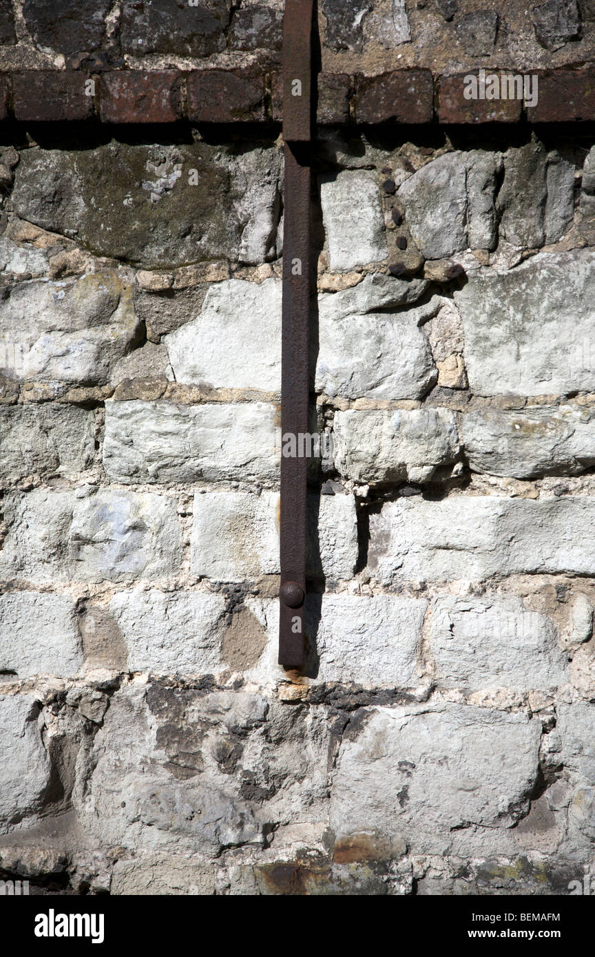 Iron support in the shape of a T, in a Reigate Stone wall, Surrey Stock ...