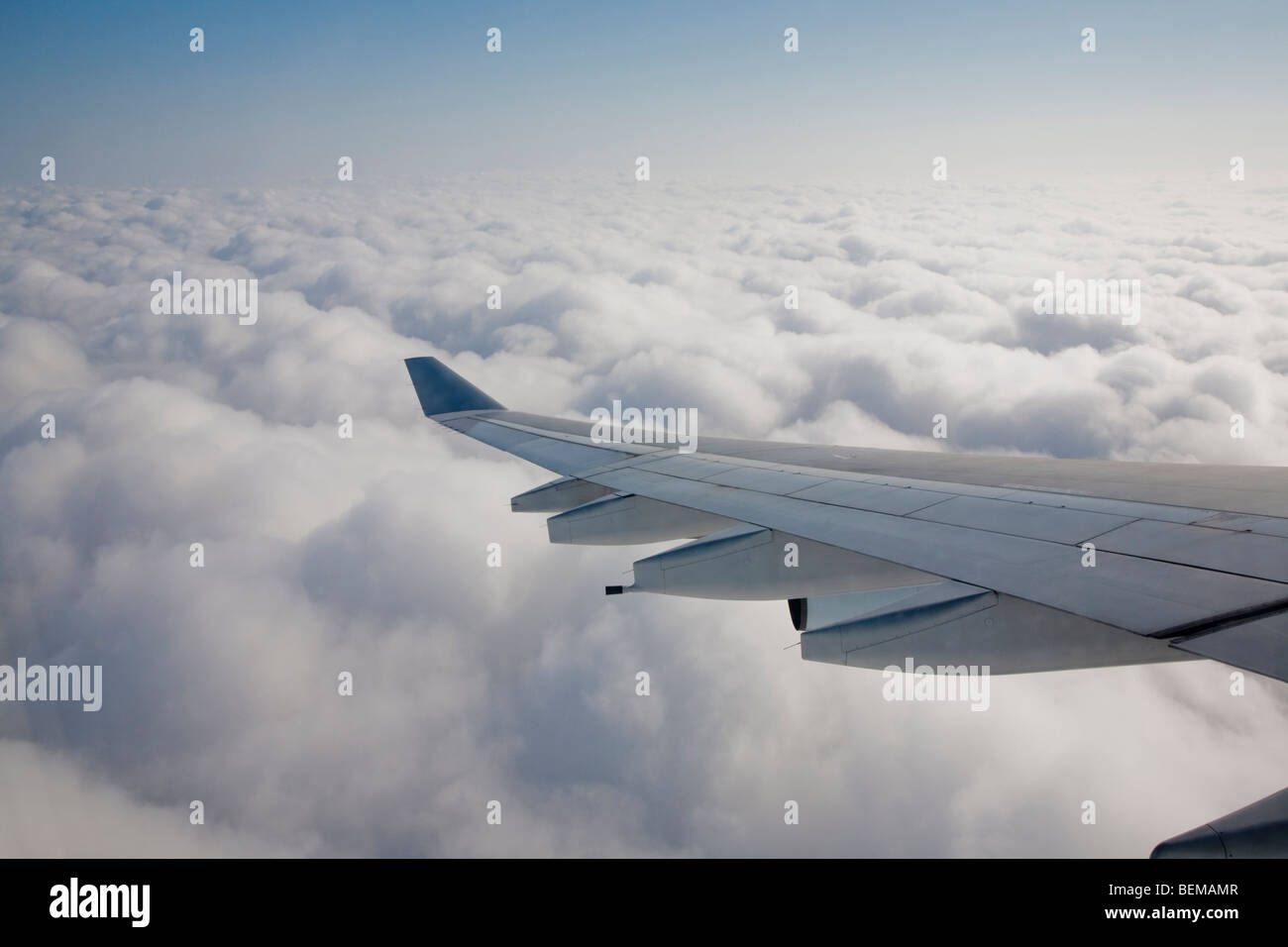 An airplane wing above clouds. The airplane is Airbus A340, operated by ...
