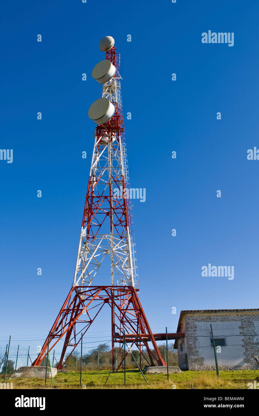Telecommunications tower with parabolic antennas over a blue sky Stock ...