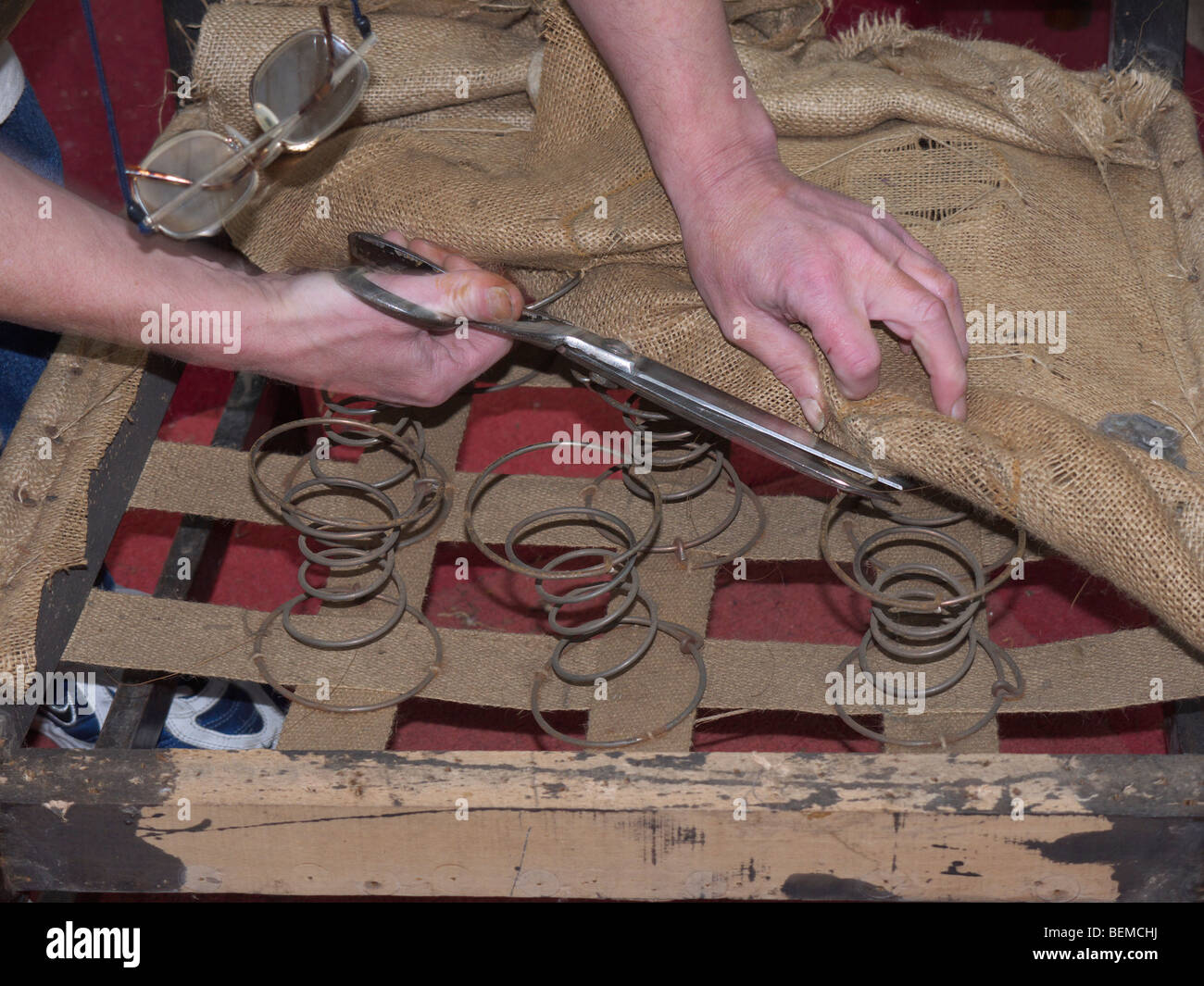 Upholsterer at work on antique chair Stock Photo - Alamy