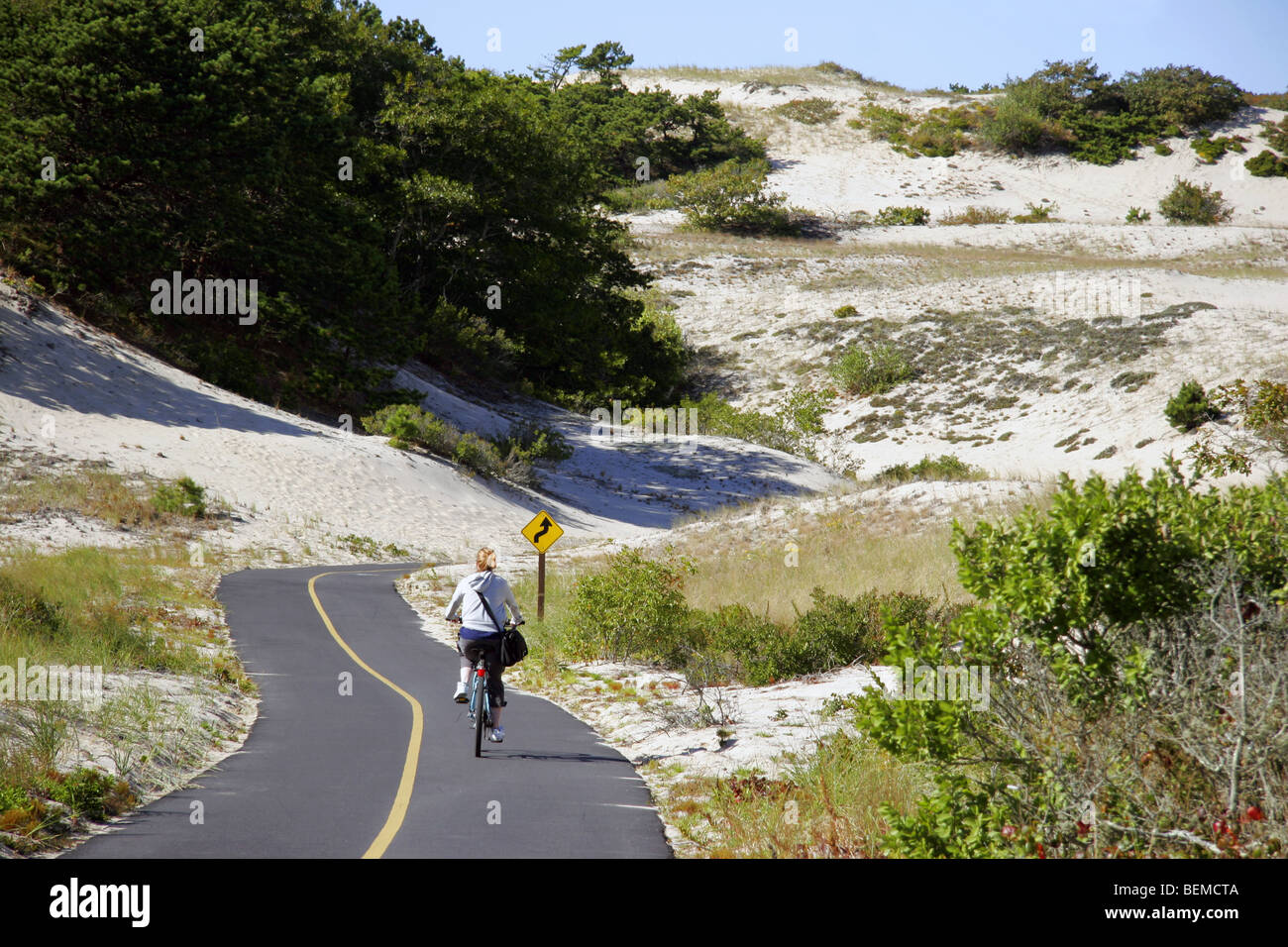 Girl riding bicycle on cycle route on Cape Cod shore, Provincetown ...