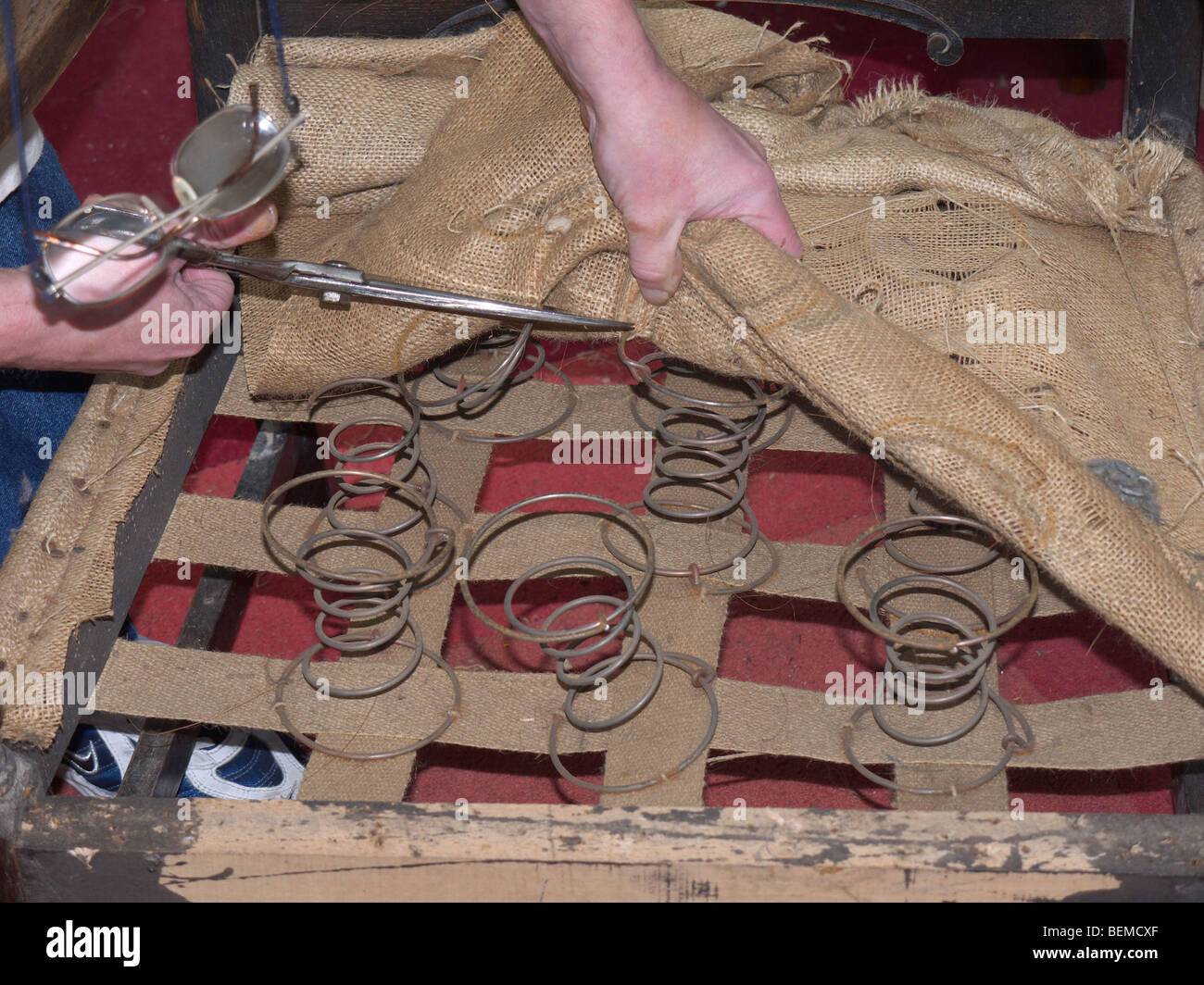 Upholsterer at work on antique chair Stock Photo - Alamy