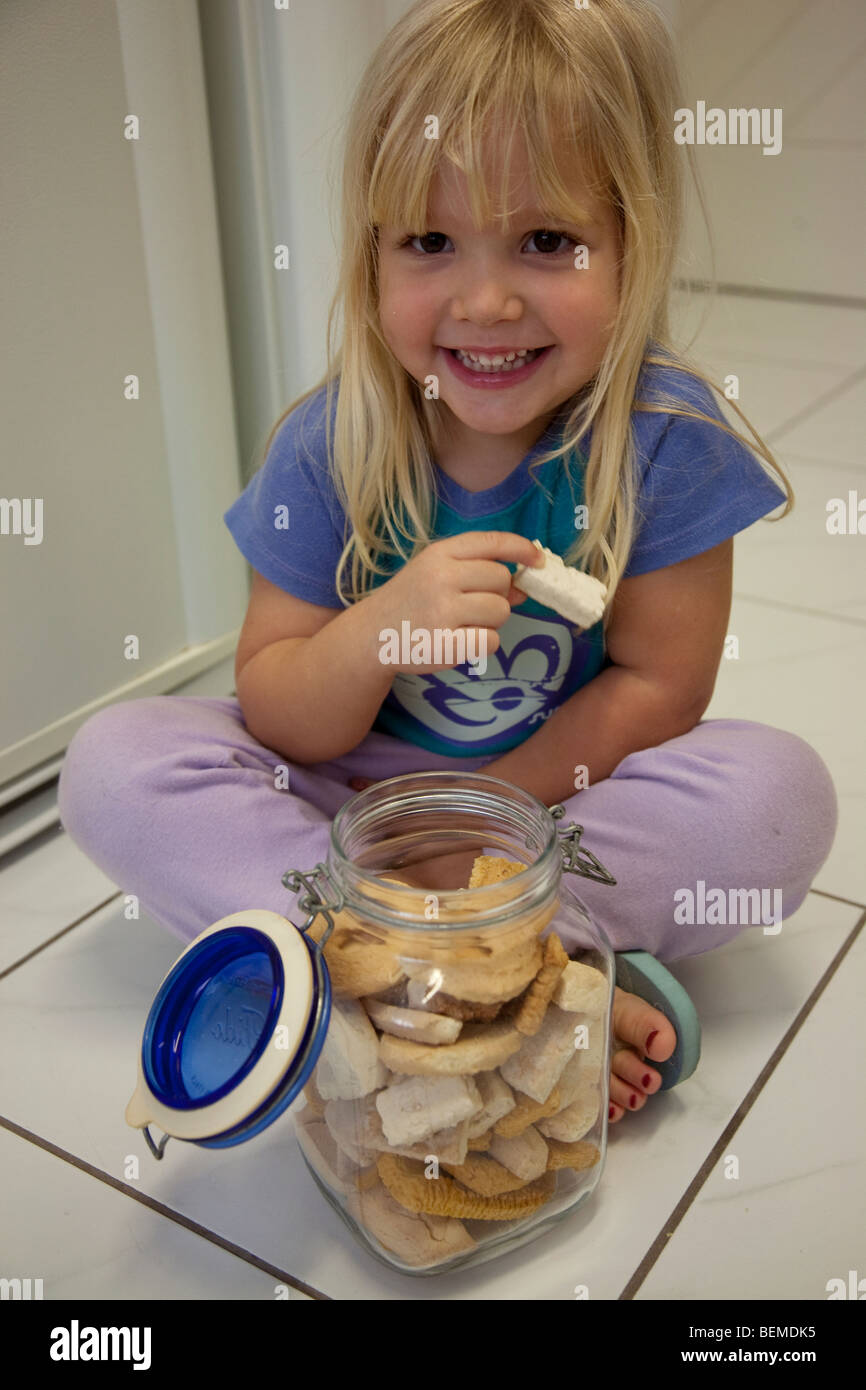 gorgeous young girl eating biscuits Stock Photo - Alamy
