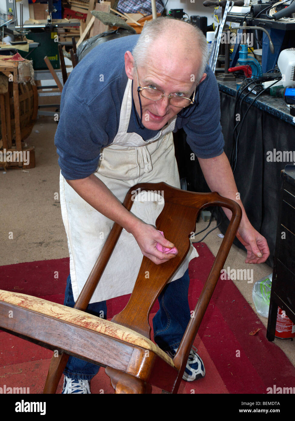 Upholsterer at work on antique chair Stock Photo - Alamy