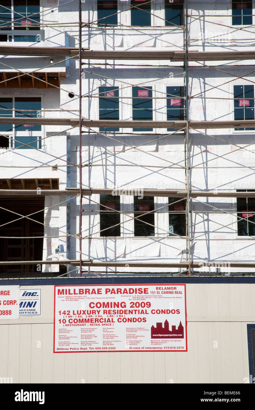 Scaffolding on a mixed use apartment block, an advertising sign ...