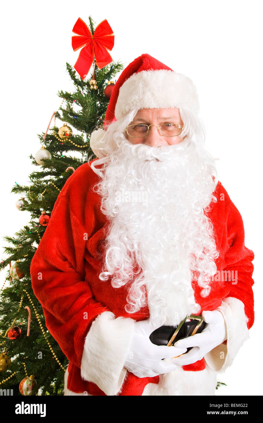 Portrait of jolly Santa Claus in front of a Christmas tree. White ...