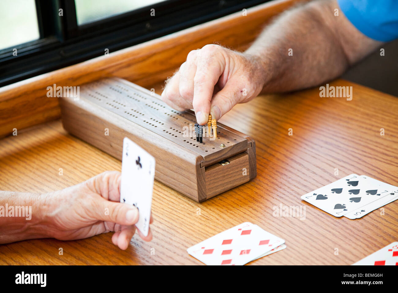 Closeup of seniors hands playing a game of cribbage Stock Photo - Alamy