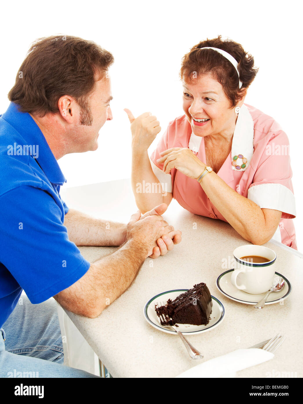 Waitress in a diner chats with a customer over coffee and cake. White ...