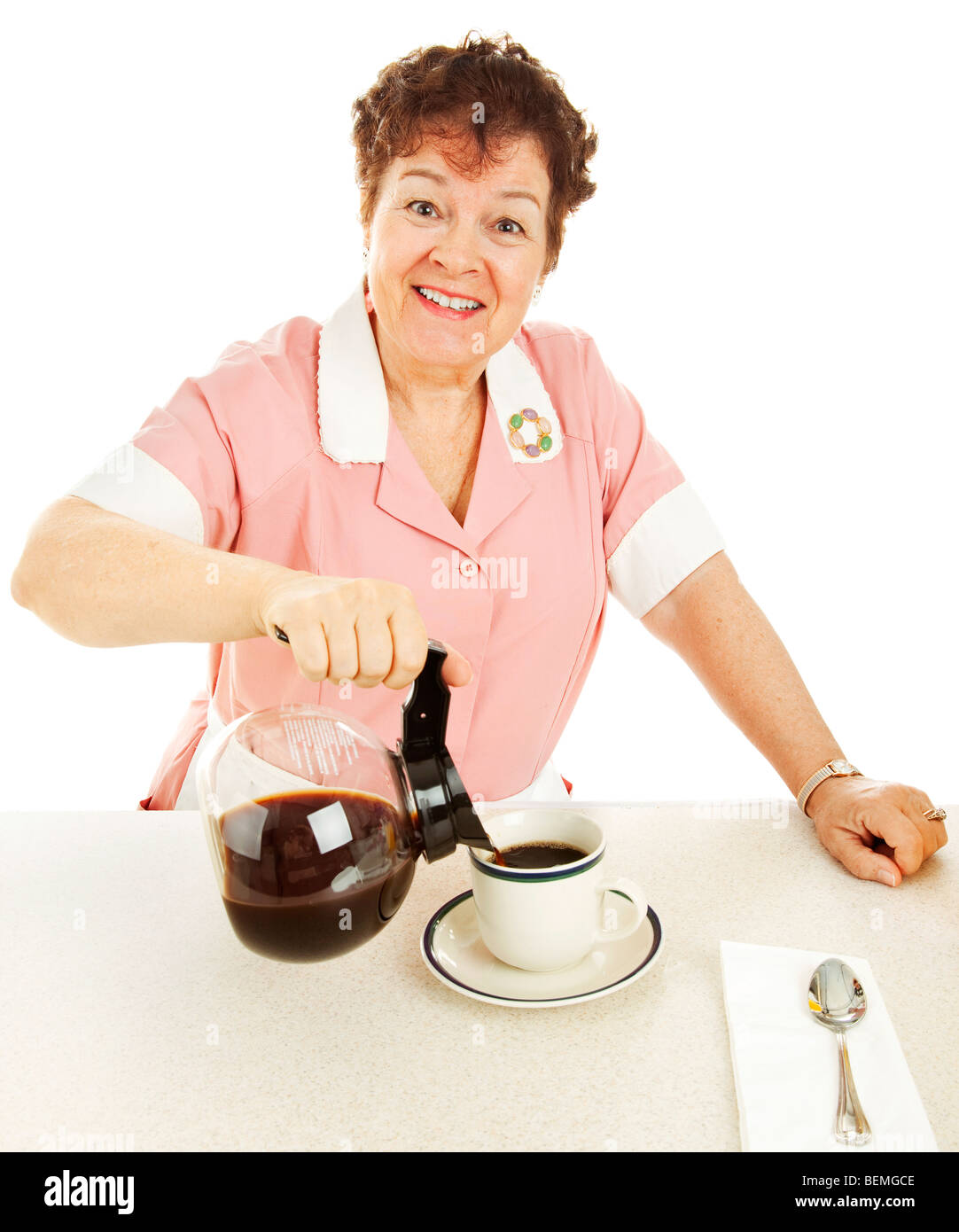 Friendly waitress at a lunch counter, pouring a cup of coffee. Isolated ...